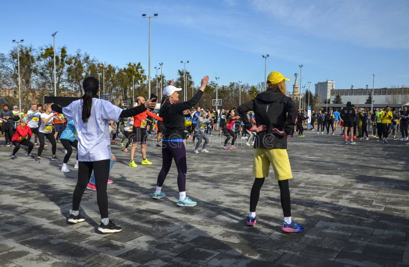 Group of Runners Warming Up and Stretching before the Running Editorial ...