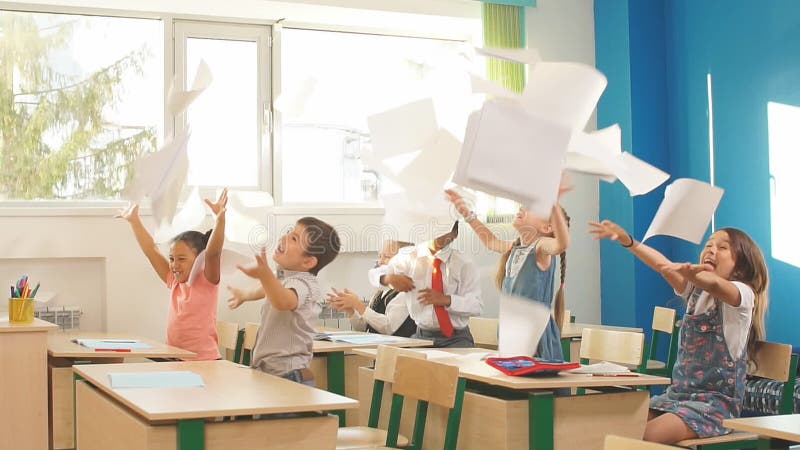 School Kids Have Fun in Class and Throwing Paper in Air Stock Footage ...