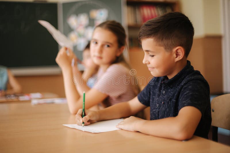Group of School Kids with Pens and Notebooks Writing Test in Classroom ...