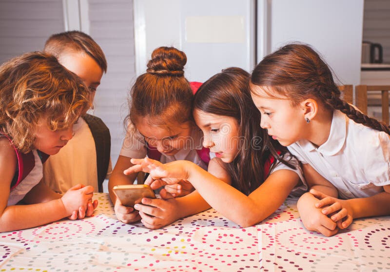 Group of School Kids with Smartphone Having Fun on Break in Classroom ...