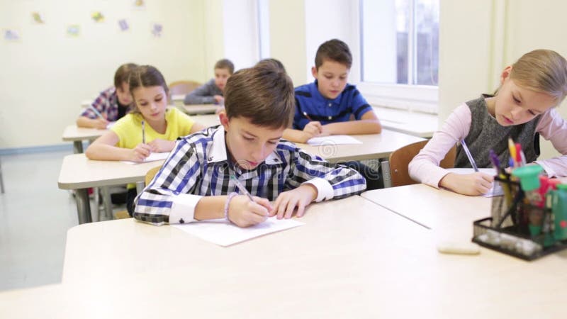 Group of School Kids Writing Test in Classroom Stock Video - Video of ...