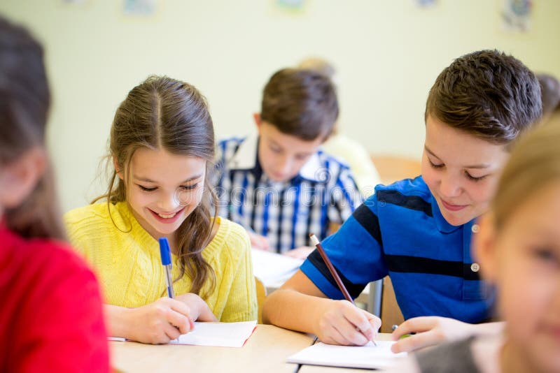 Group of School Kids Writing Test in Classroom Stock Photo - Image of ...