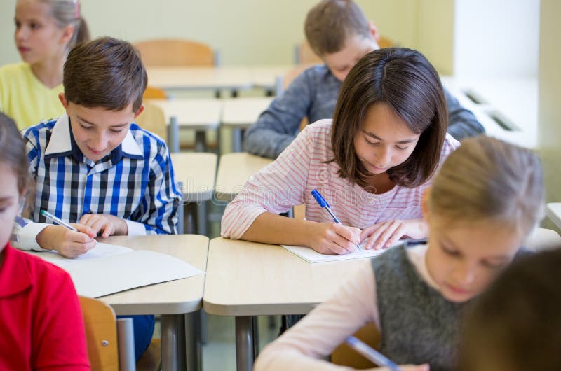 Group of School Kids Writing Test in Classroom Stock Photo - Image of ...