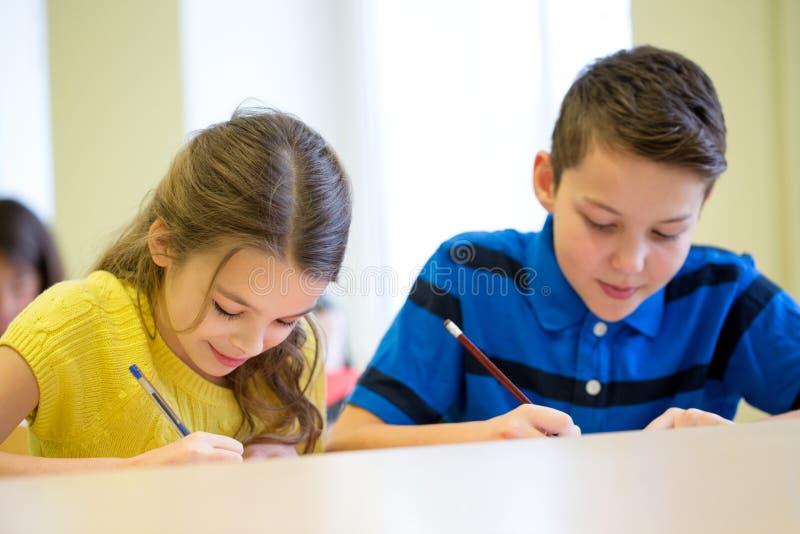 Group Of School Kids Writing Test In Classroom Stock Photo - Image ...