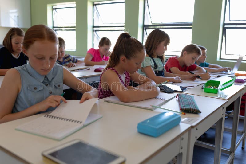 Group of Schoolchildren Sitting at Desks in an Elementary School ...