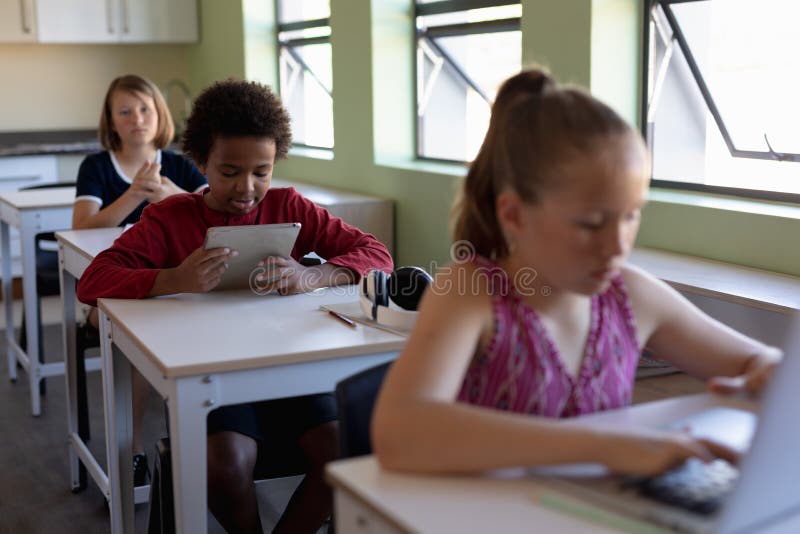 Group Schoolchildren Sitting at Desks Using Personal Computers Stock ...