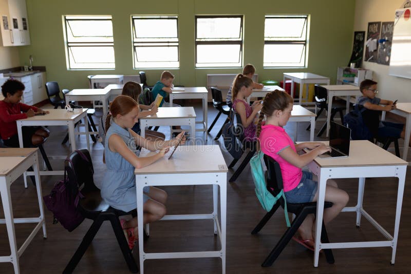 Group of Schoolchildren Sitting at Desks Using Personal Computers Stock ...