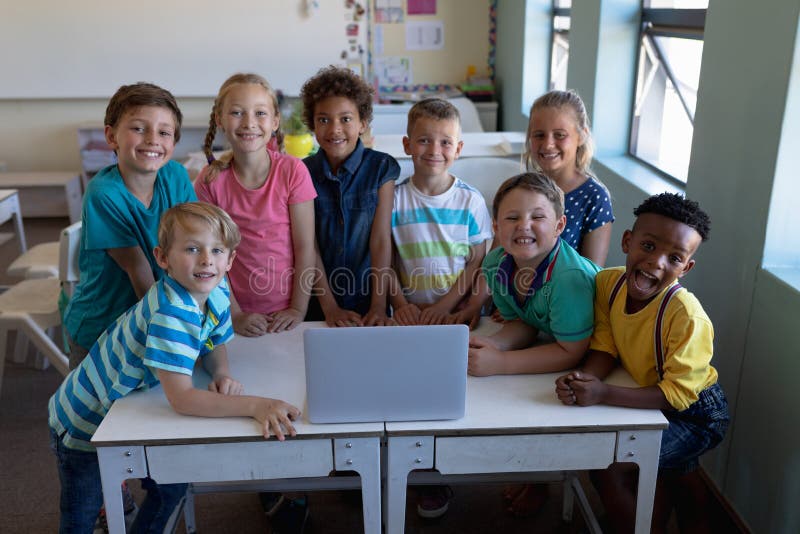 Group of Schoolchildren Using a Laptop Computer in an Elementary School ...