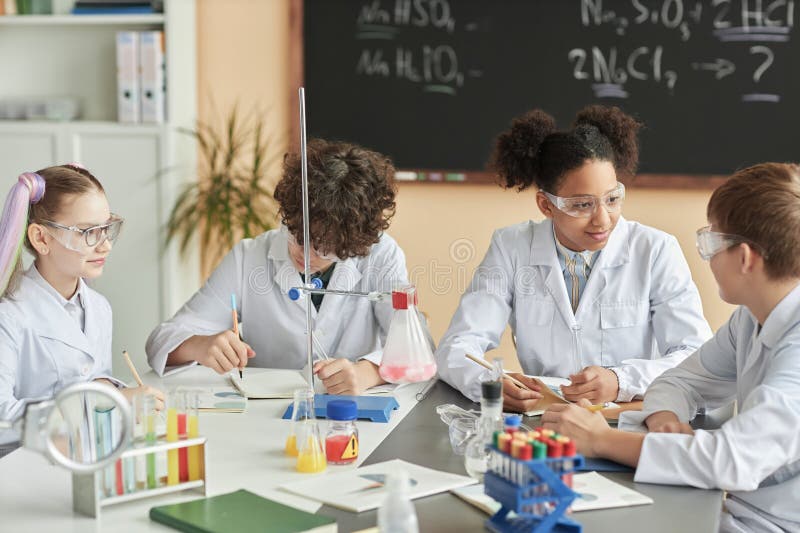 Group of Schoolchildren Wearing Lab Coats during Science Experiment ...