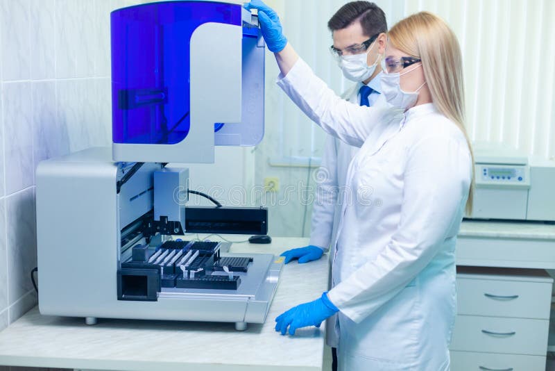 A Group of Scientists Conducts Research in a Scientific Laboratory ...