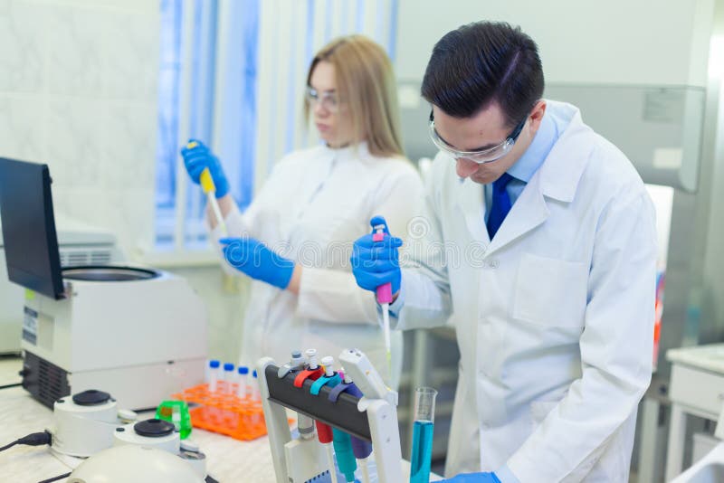 A Group of Scientists Conducts Research in a Scientific Laboratory ...