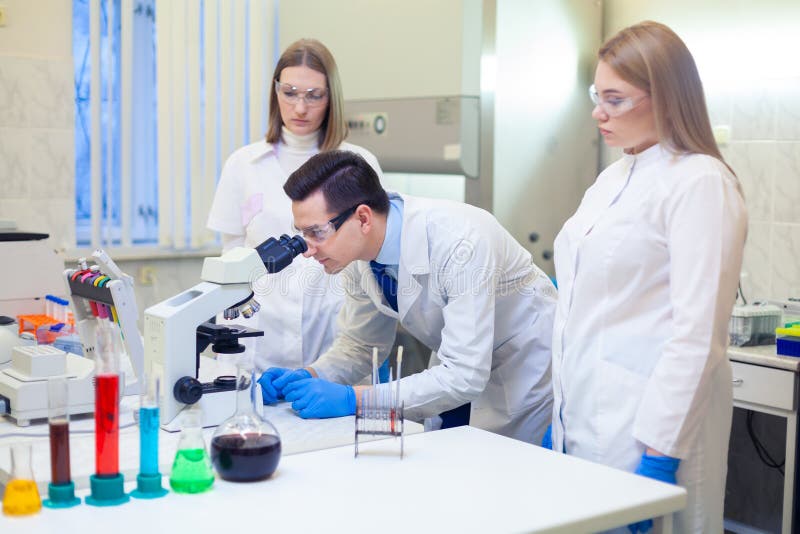 A Group of Scientists Conducts Research in a Scientific Laboratory ...