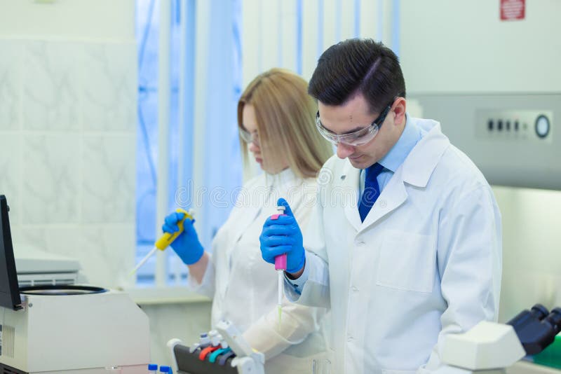 A Group of Scientists Conducts Research in a Scientific Laboratory ...