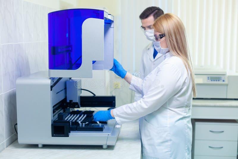 A Group of Scientists Conducts Research in a Scientific Laboratory ... A Group of Scientists Conducts Research in a Scientific Laboratory ...