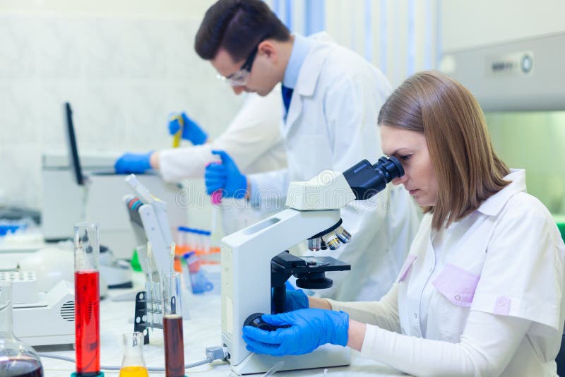 A Group of Scientists Conducts Research in a Scientific Laboratory ...