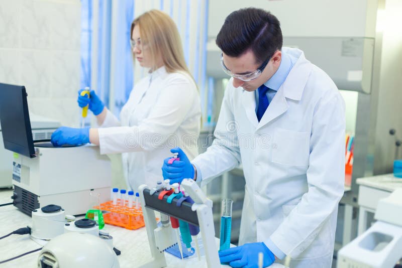 A Group of Scientists Conducts Research in a Scientific Laboratory ...