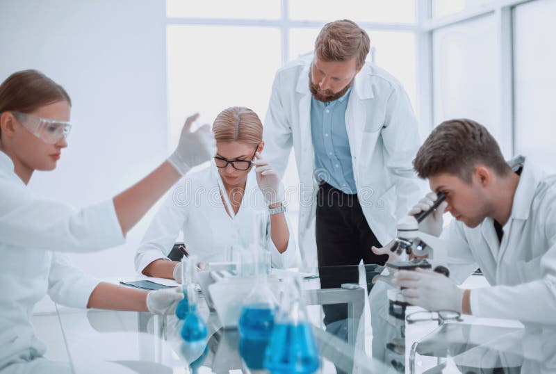 Group of Scientists and Doctors Sitting at a Laboratory Table Stock ...