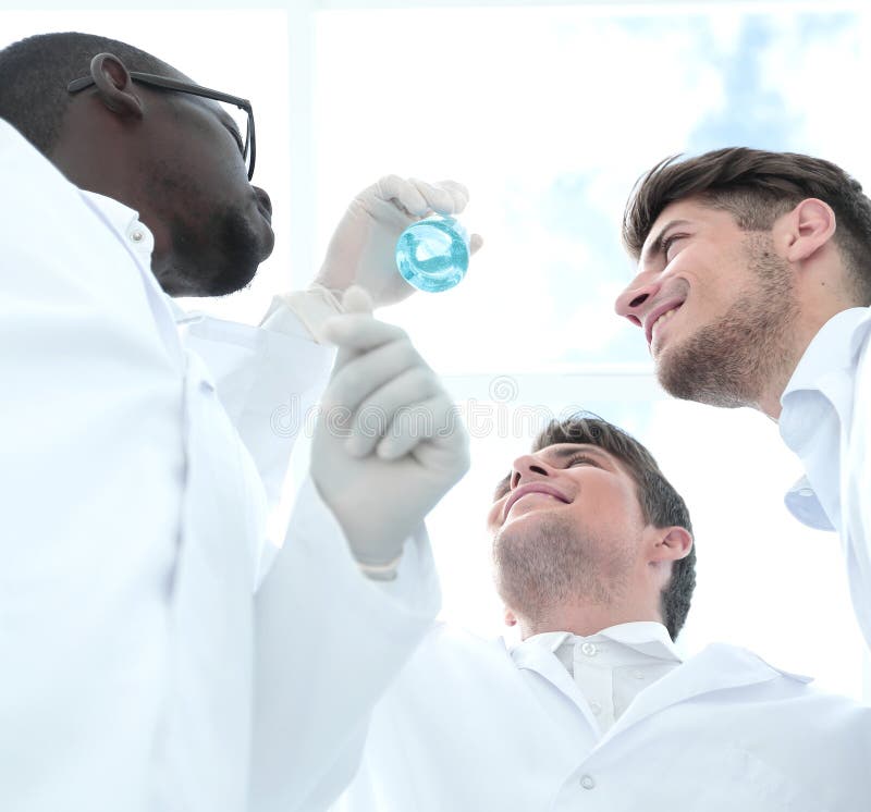 Group of Scientists Looking at the Results of Their Experiment. Stock ...