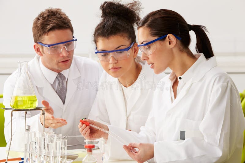 Group of Scientists Performing Experiment in Laboratory Stock Photo ...
