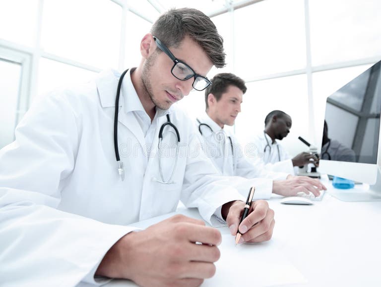 Group of Scientists Sitting at the Laboratory Table Stock Photo - Image ...