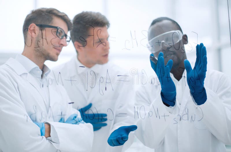 Group of Scientists Talking Standing Near a Glass Board. Stock Photo ...