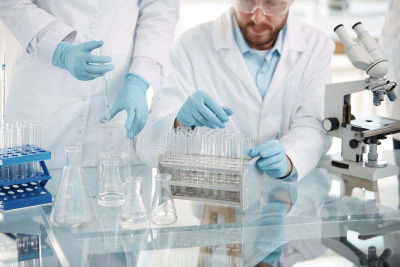Group of Scientists Testing Liquid in Laboratory Tubes . Stock Photo ...