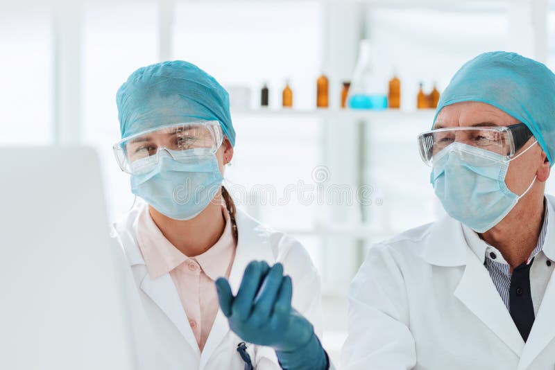 Group of Scientists Using a Computer To Classify Data. Stock Photo ...