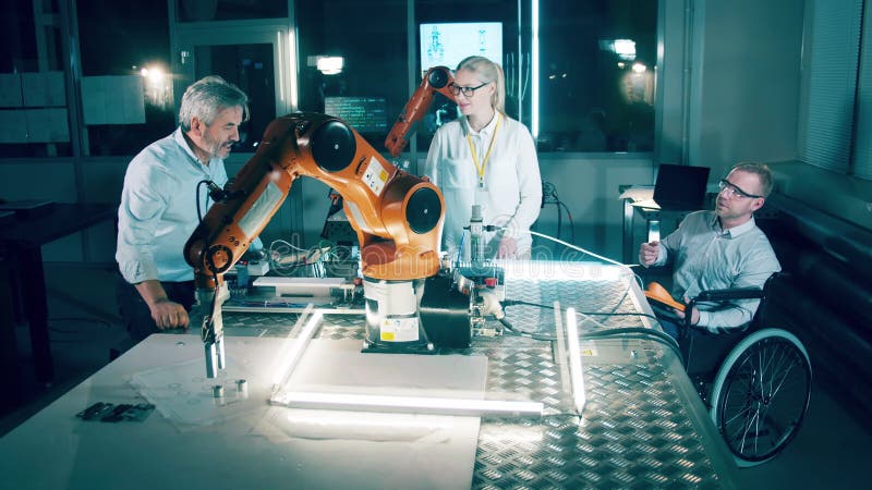 A Group of Scientists Work with Bionic Mechanisms at Modern Laboratory ...