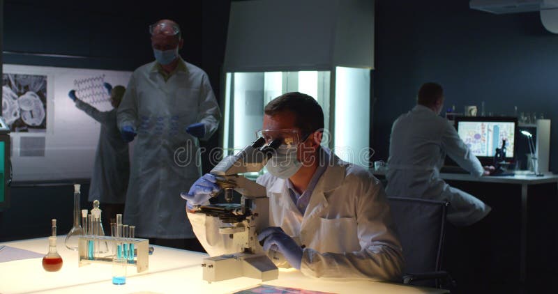 Group of Scientists Work in Microbiology Laboratory Stock Image - Image ...