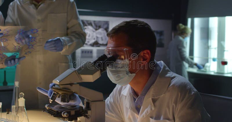 Group of Scientists Work in Microbiology Laboratory Stock Video - Video ...