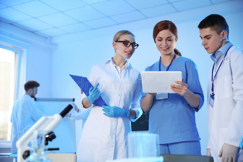 Group of Scientists Working with Sample in Chemistry Laboratory Stock ...