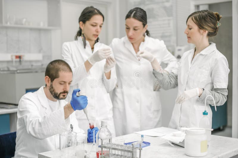 Group of Scientists Working with Liquid Test Tube Samples Stock Image ...