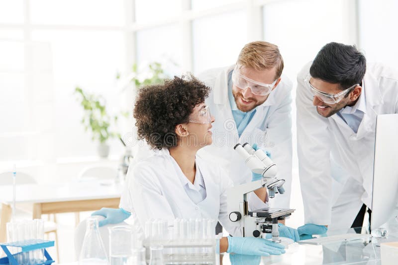 Group of Scientists Working with a Microscope To Develop a Vaccine ...