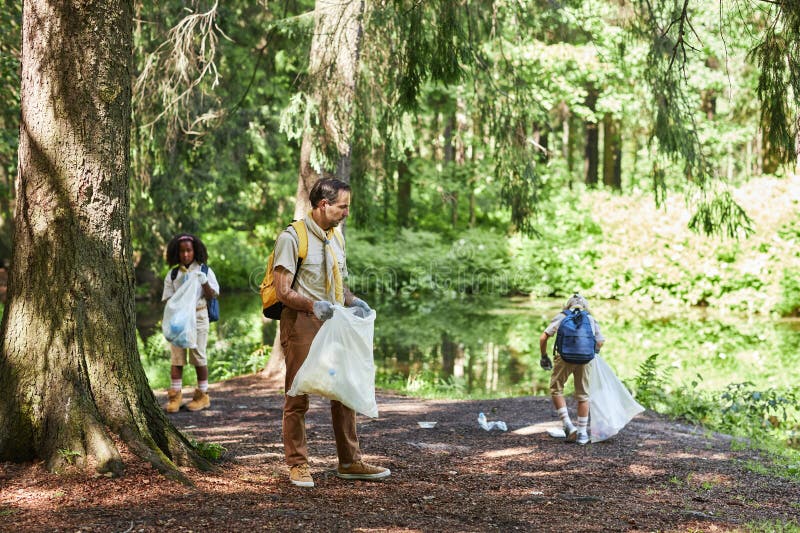 Group of Scouts Cleaning Forest with Focus on Leader in Foreground ...