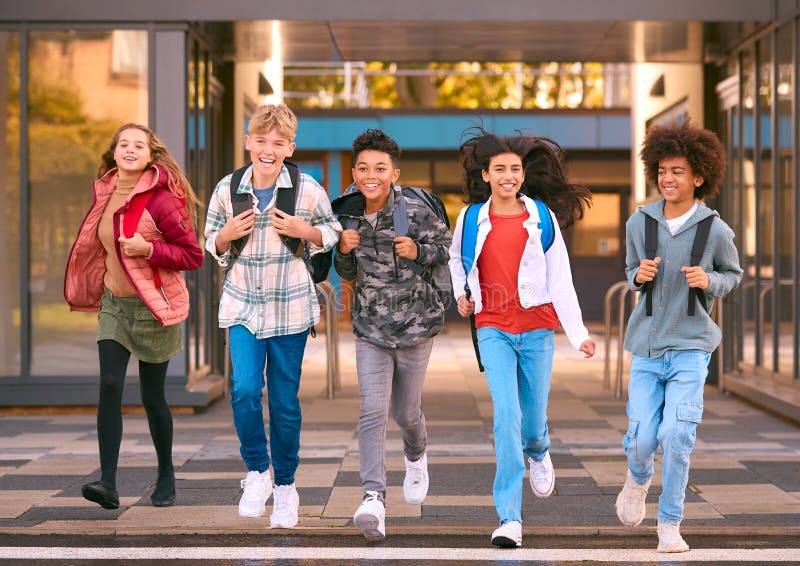 Group of Secondary or High School Pupils Running Towards Camera Outside ...