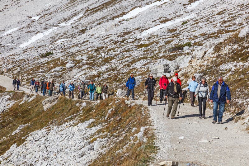 Group with Senior Citizen Walking on a Mountain Path Editorial Stock ...