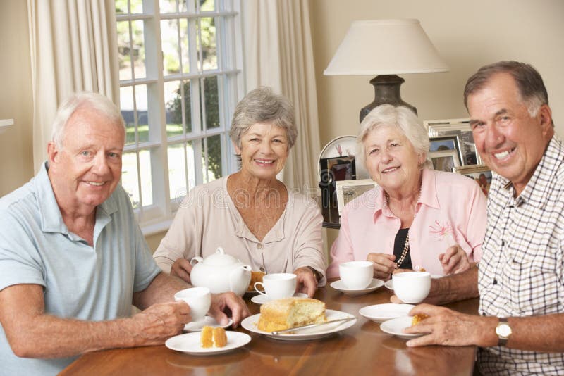 Group of Senior Couples Enjoying Afternoon Tea Together at Home Stock ...