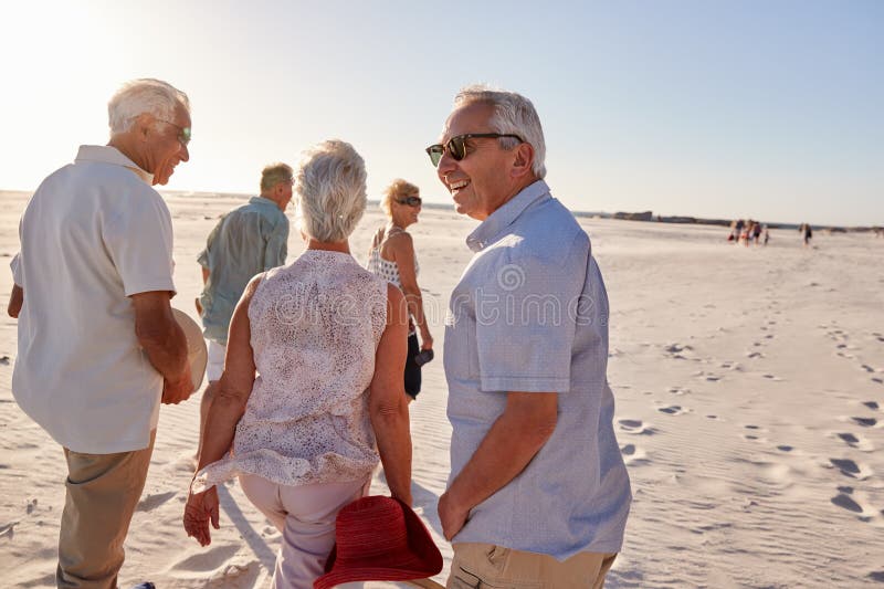 Group of Senior Friends Walking Along Sandy Beach on Summer Group ...
