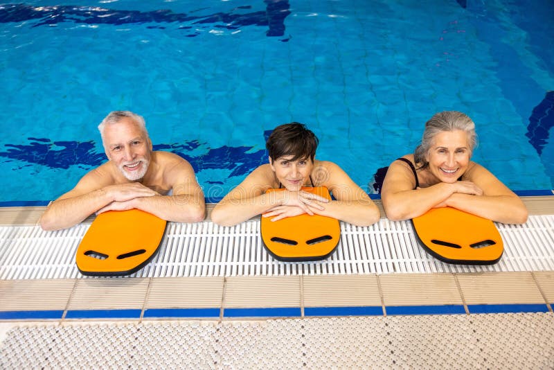 Group of Senior Swimmers Resting on the Pool Side Stock Photo - Image ...