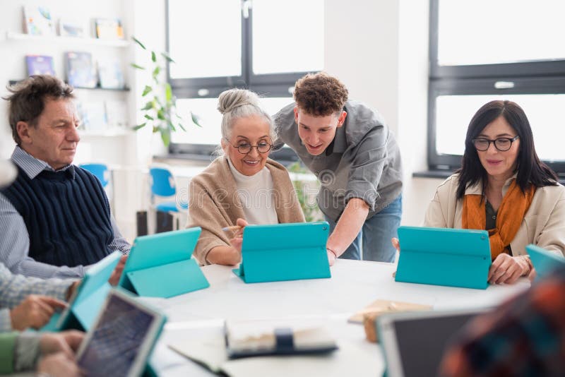 Group of Seniors Attending it Class in Community Centre with Teacher ...