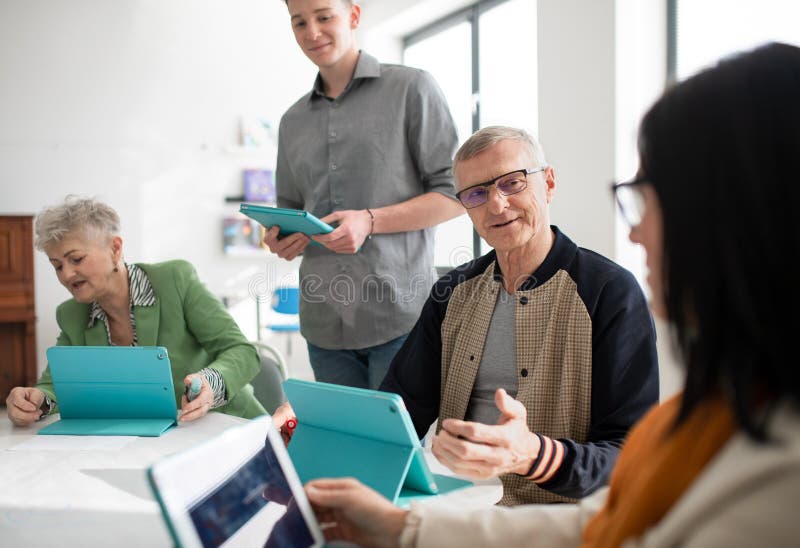 Group of Seniors Attending it Class in Community Centre with Teacher ...