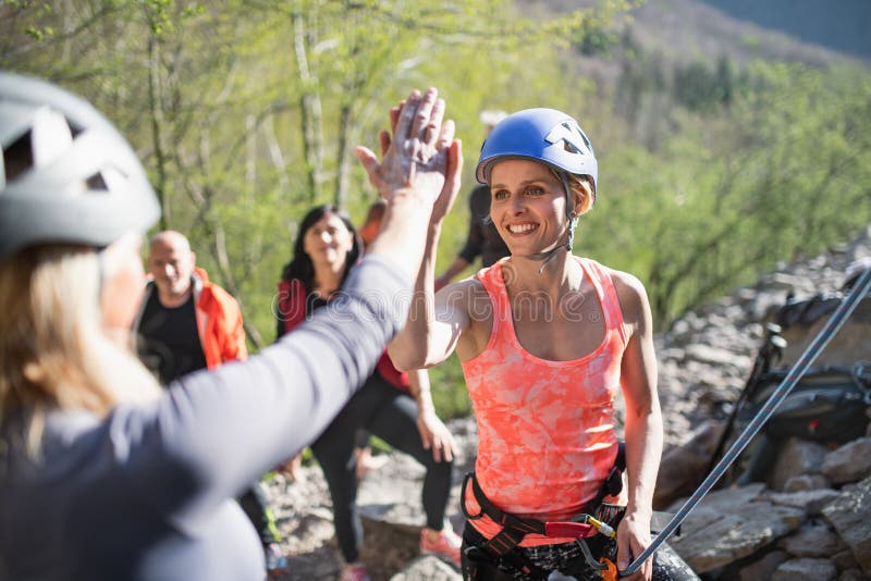 Group of Seniors with Instructor Climbing Rocks Outdoors in Nature ...