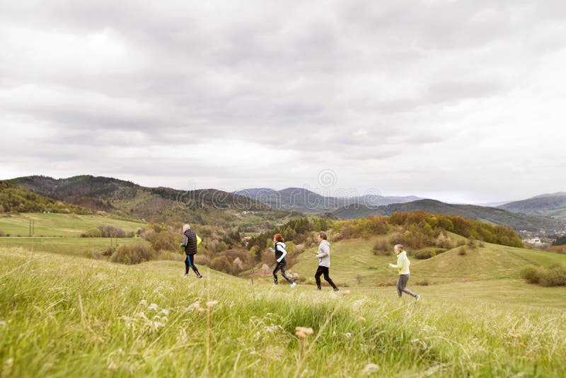 Group of Seniors Running Outside on the Green Hills. Stock Image ...