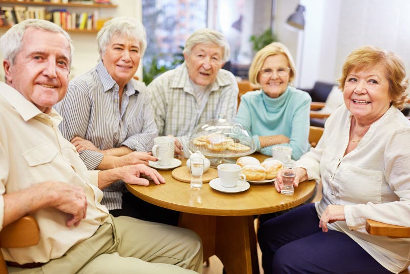 Group of Seniors Sits Together at the Coffee Table Stock Photo - Image ...