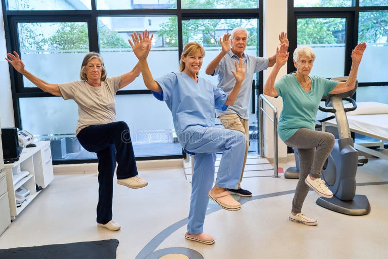 Group of Seniors and Trainer in an Exercise Session at Rehabilitation ...