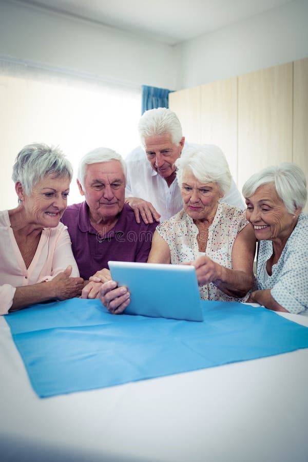 Group of Seniors Using a Tablet Computer Stock Photo - Image of ...