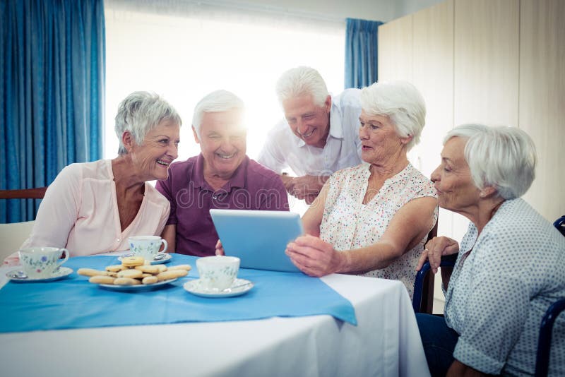 Group of Seniors Using a Tablet Computer Stock Photo - Image of monitor ...