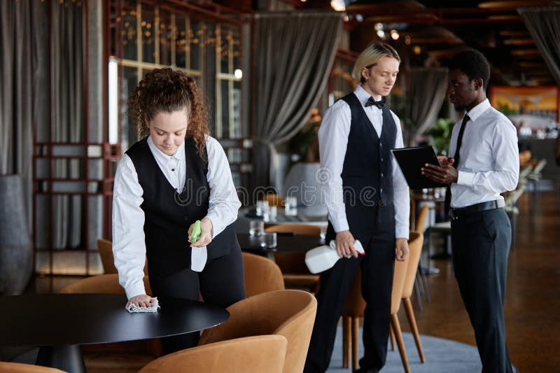 Group of Servers in Classic Uniform Preparing Restaurant for Opening ...