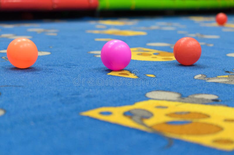 A Group of Several Colored Balls Scattered on the Floor of the Game ...