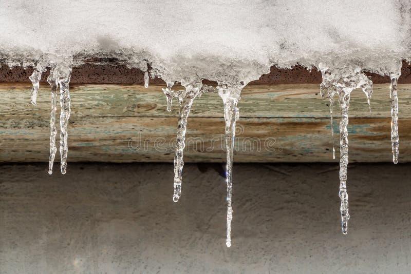 Group of Sharp White and Red Transparent Icicles is Hanging Down from ...